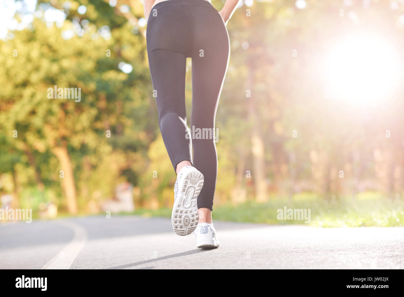 Female runner jogging in the forest Stock Photo - Alamy