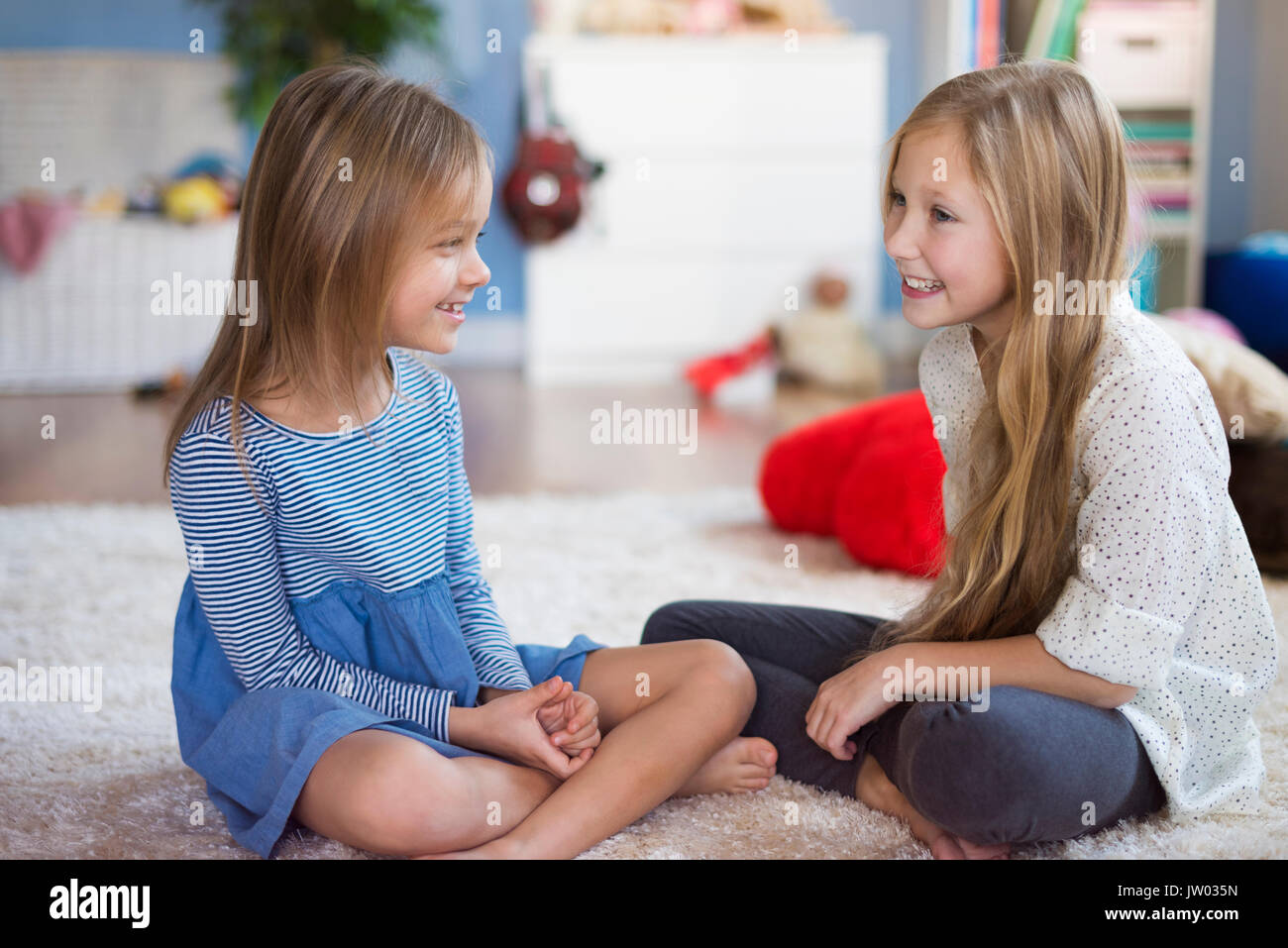 Girls talking to each other in the living room Stock Photo - Alamy
