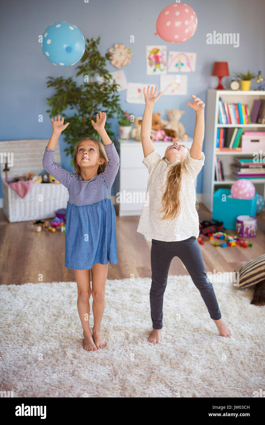 Great fun while throwing a balloon Stock Photo - Alamy