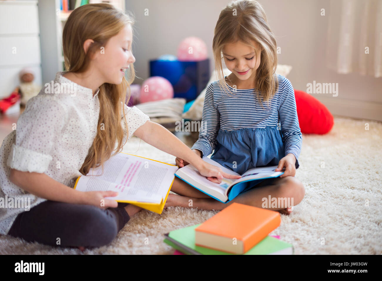 Sisters talking reading book hi-res stock photography and images - Alamy