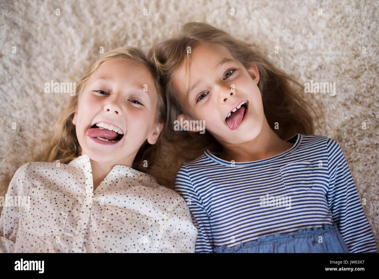 Cute girls making funny faces Stock Photo - Alamy