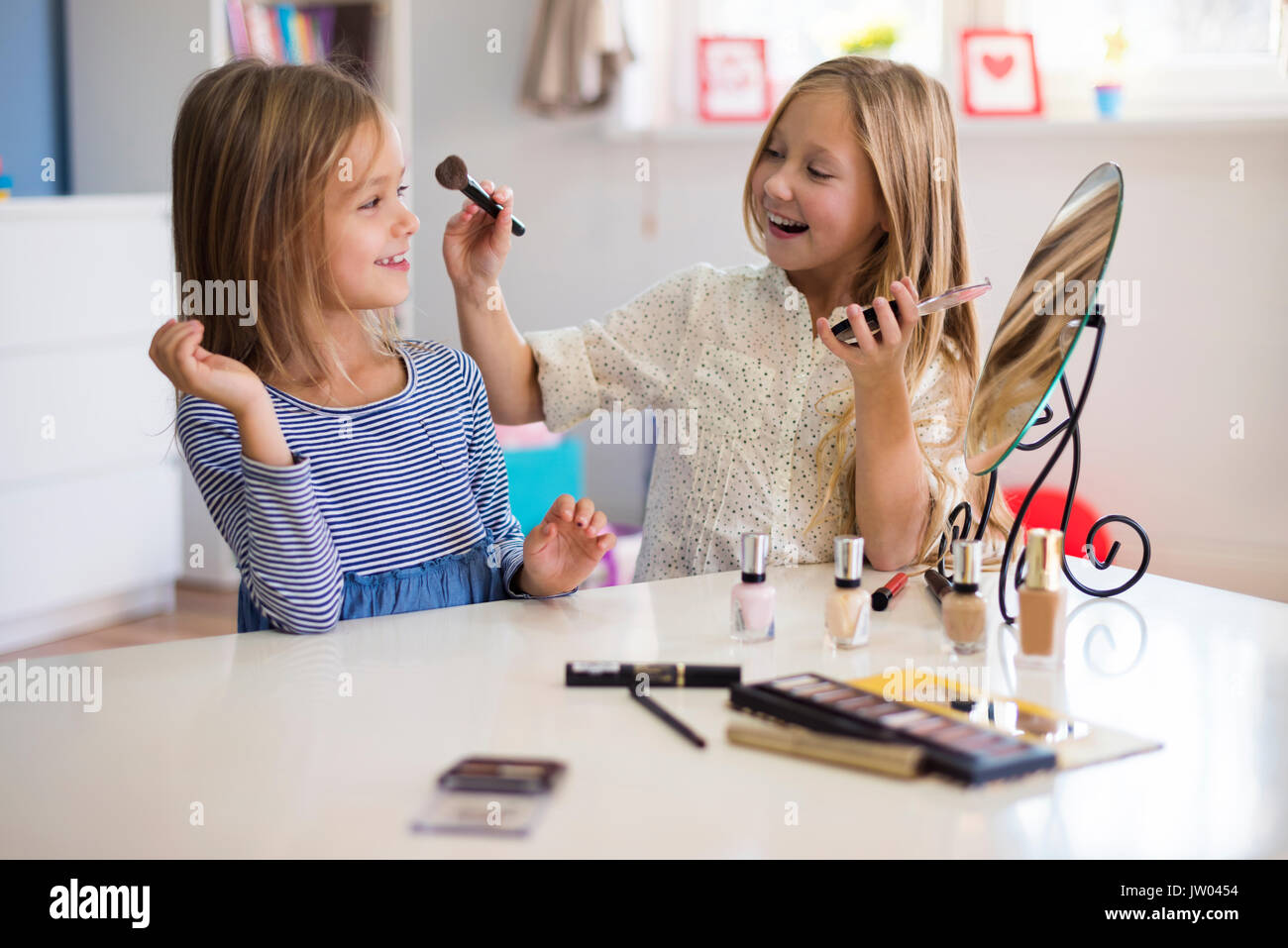 Her sister is a great helper Stock Photo - Alamy