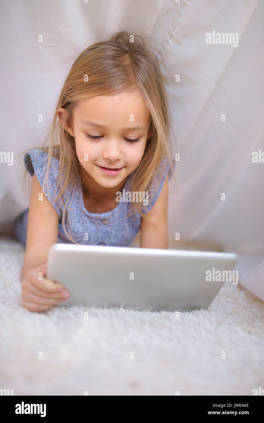 Girl playing on a tablet hi-res stock photography and images - Alamy