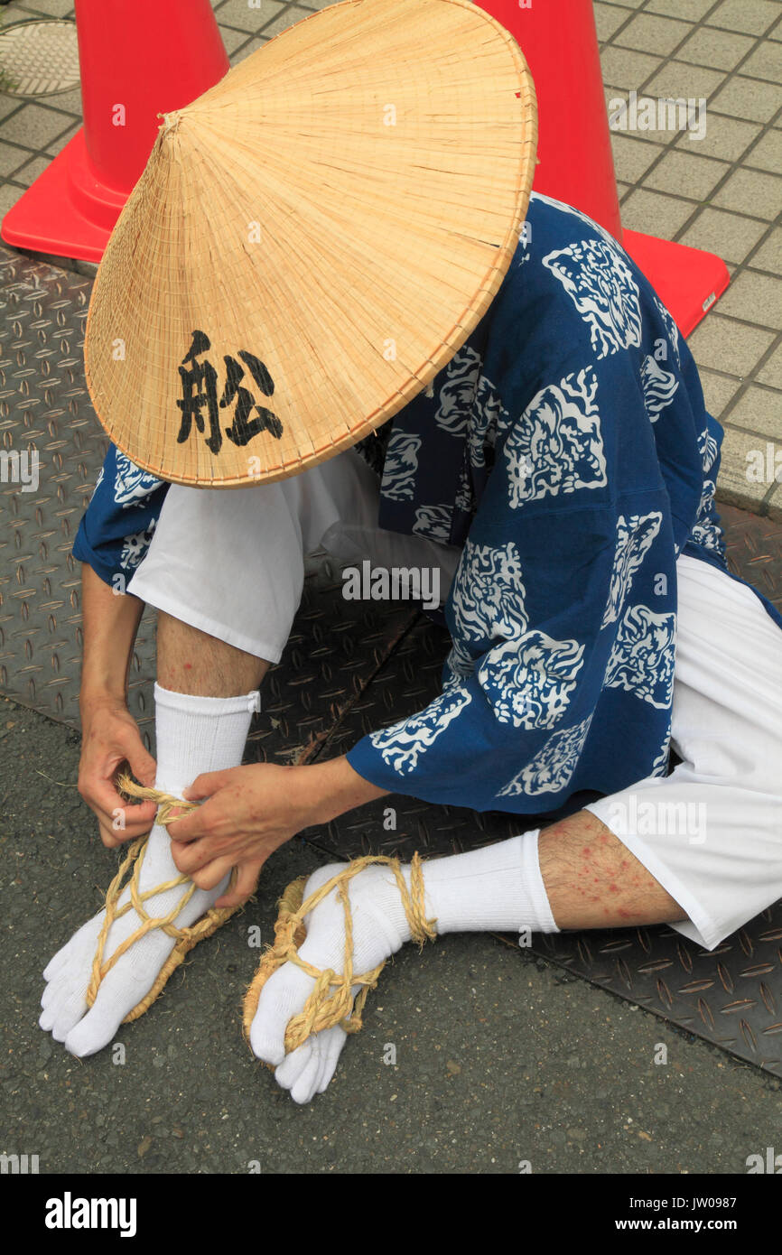 Japan, Kyoto, Gion Matsuri, festival, people, man tying rope sandals ...