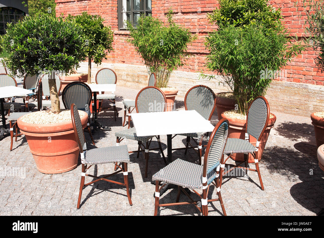 Empty street cafe near old brick building under sunlight Stock Photo ...