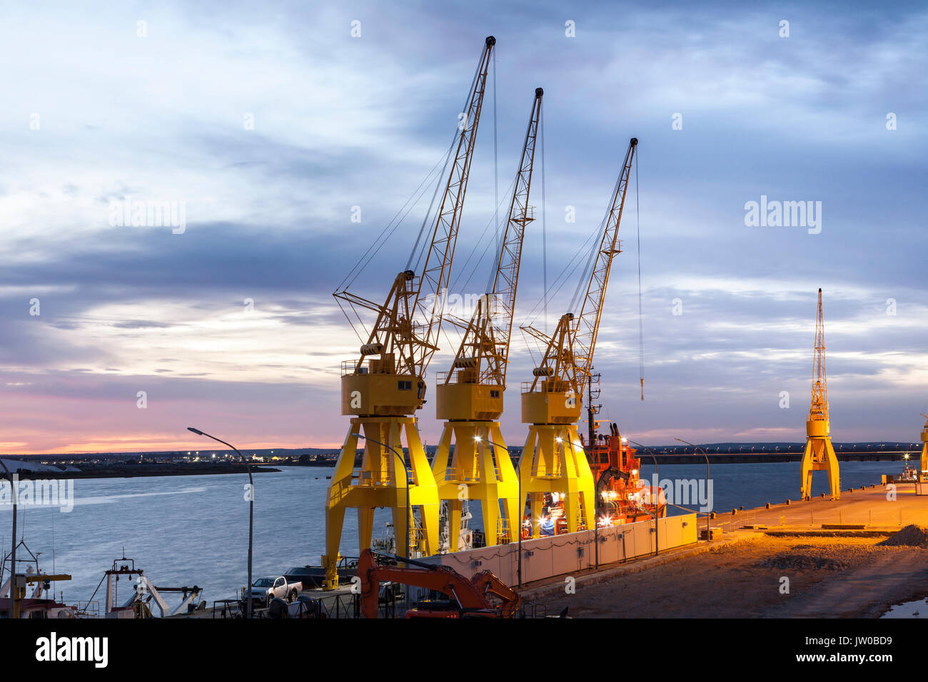 Yellow cranes in the old port of Huelva illuminated at night. Andalusia ...