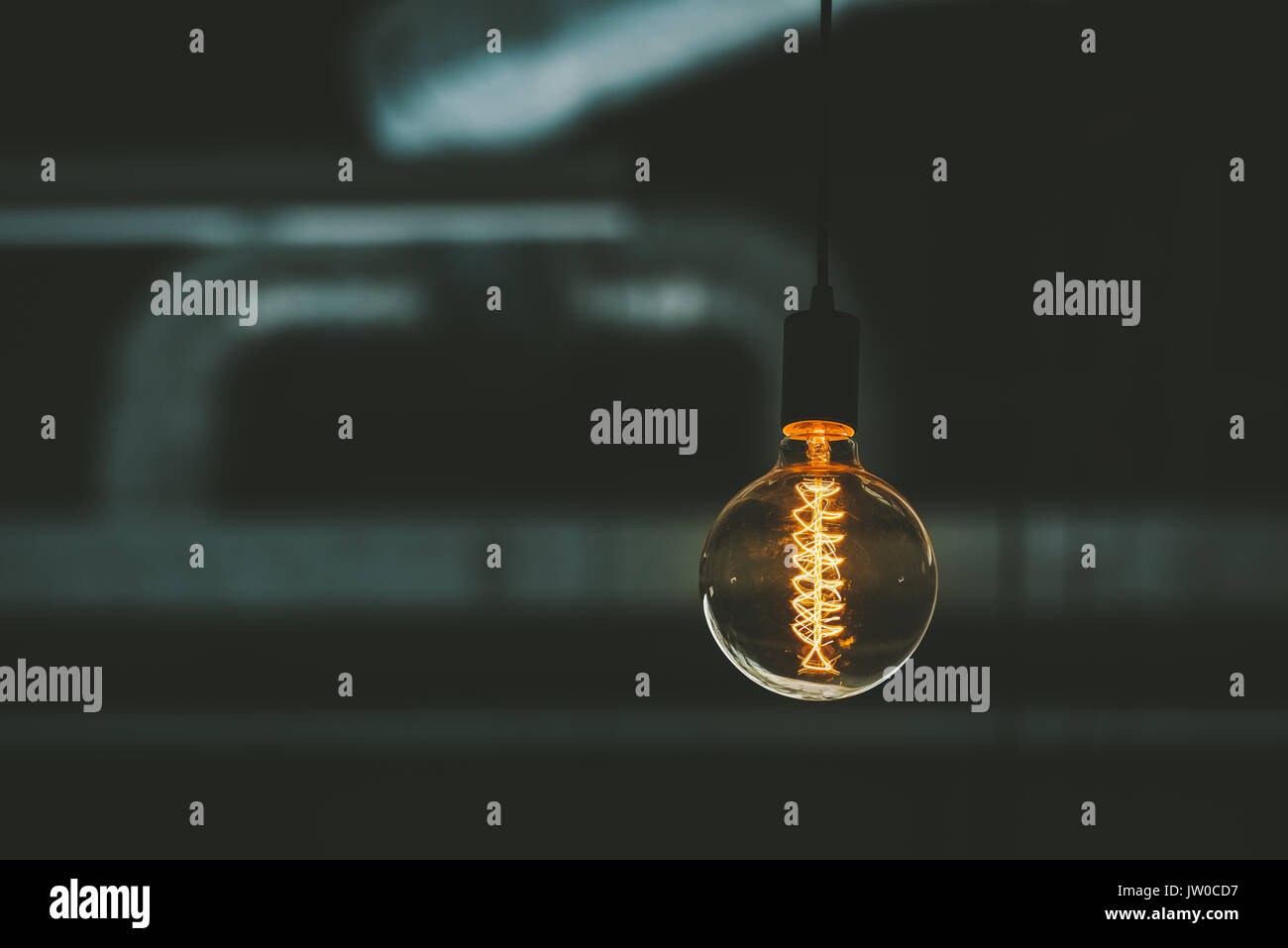 vintage edison light bulb hanging in dark room with copy space Stock ...