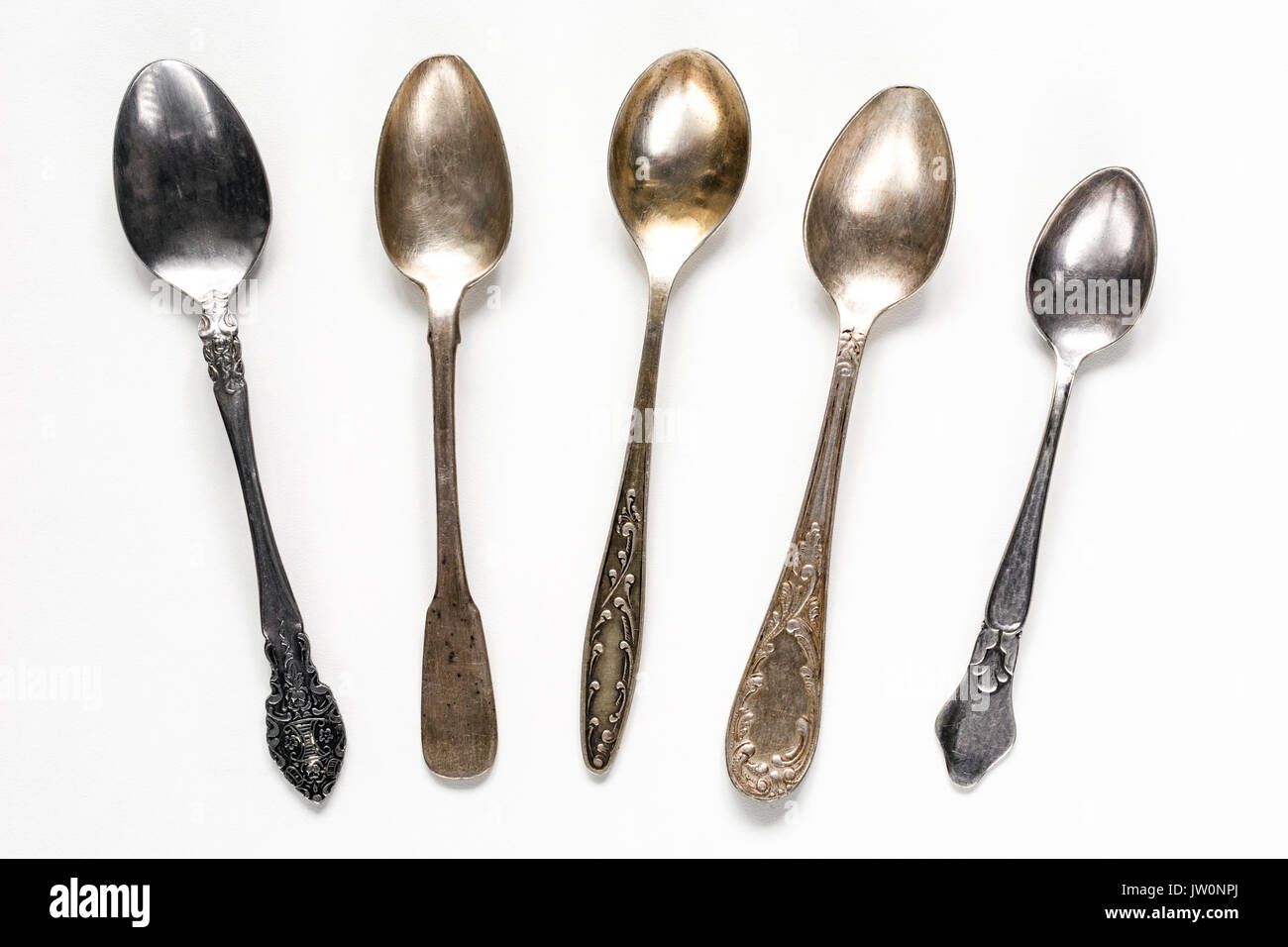 Vintage silverware, old tea spoons on white background. Table top view ...