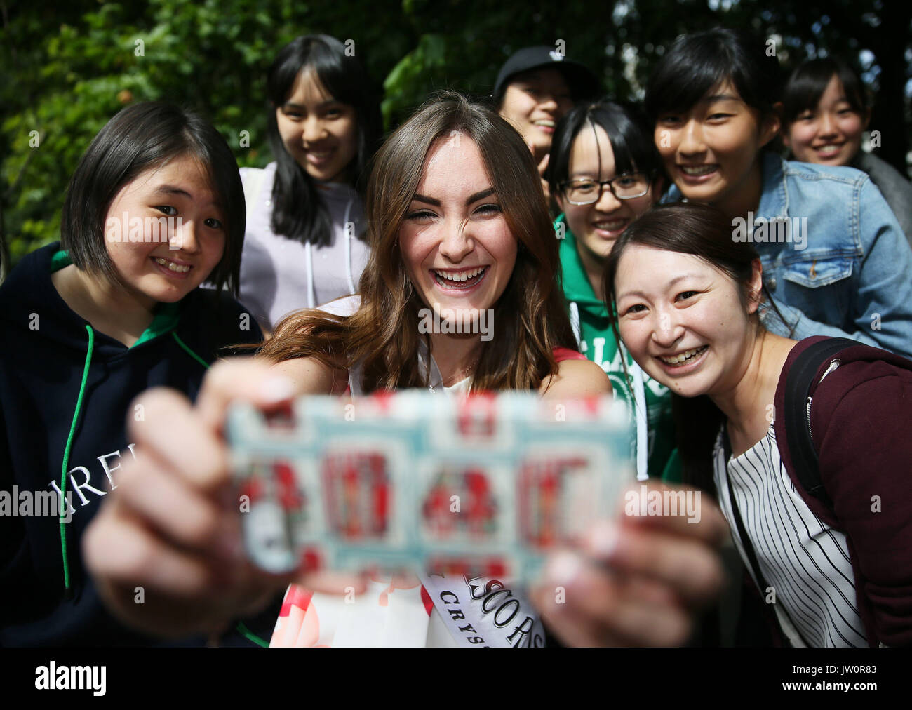 San Francisco rose Amanda Donohoe poses for a selfie with tourists as ...