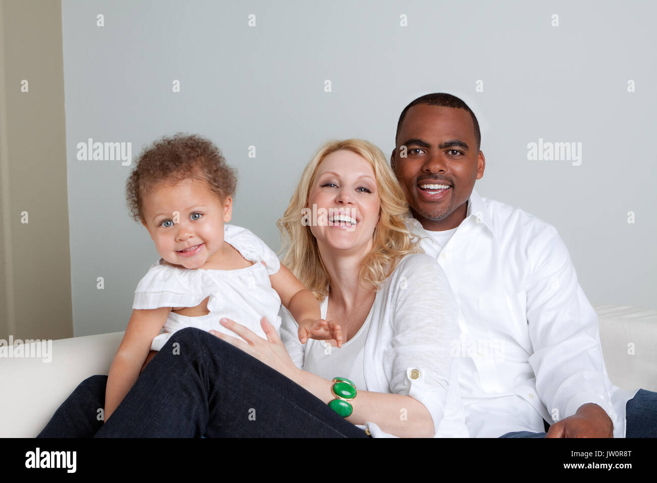 Portrait of happy multicultural family smiling Stock Photo - Alamy
