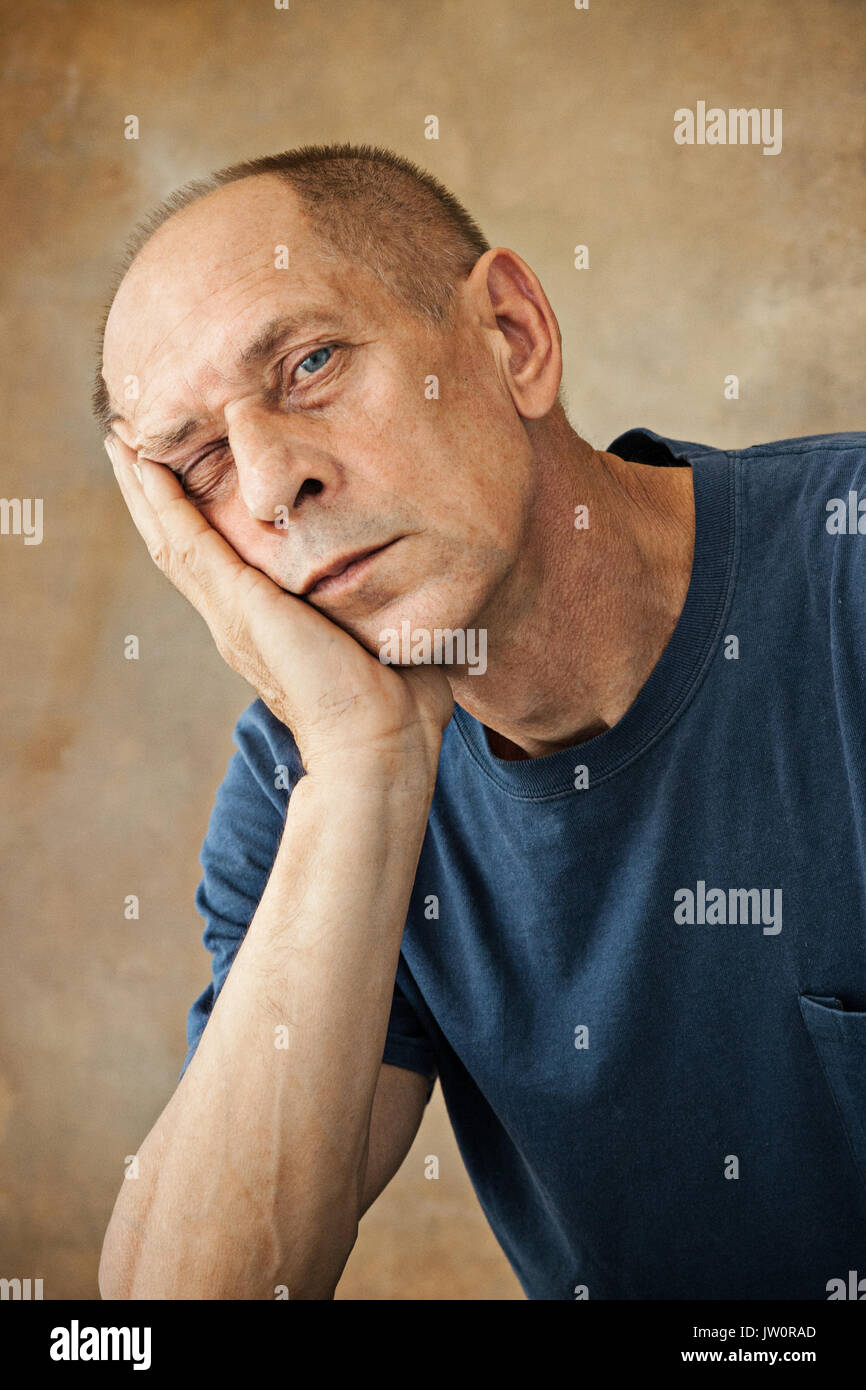 Worried mature man touching his head Stock Photo - Alamy