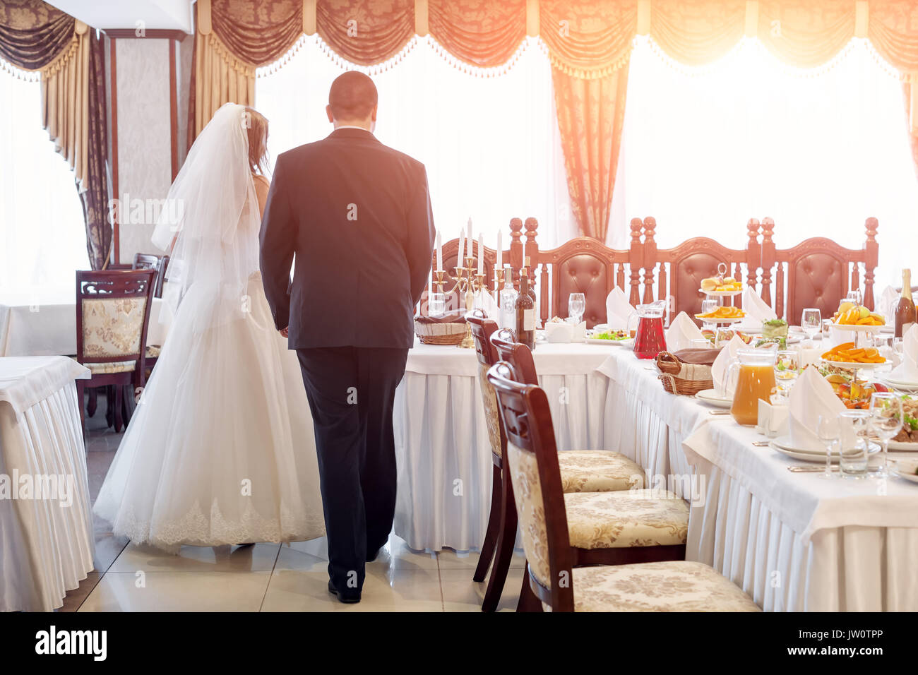 Bride and groom in restaurant. Wedding table at a wedding feast, dinner ...