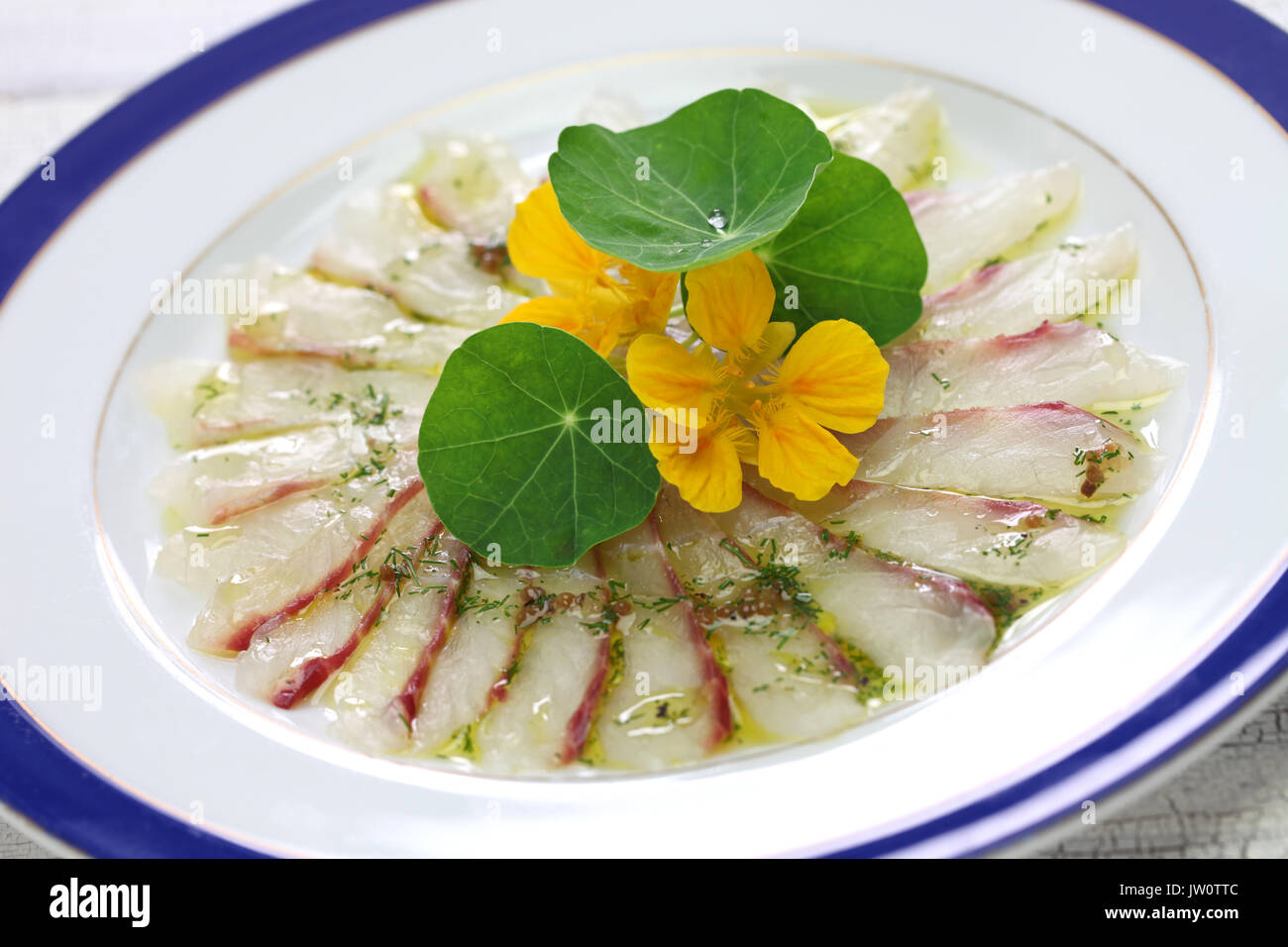 fish carpaccio, thinly sliced raw sea bream appetizer, italian dish ...