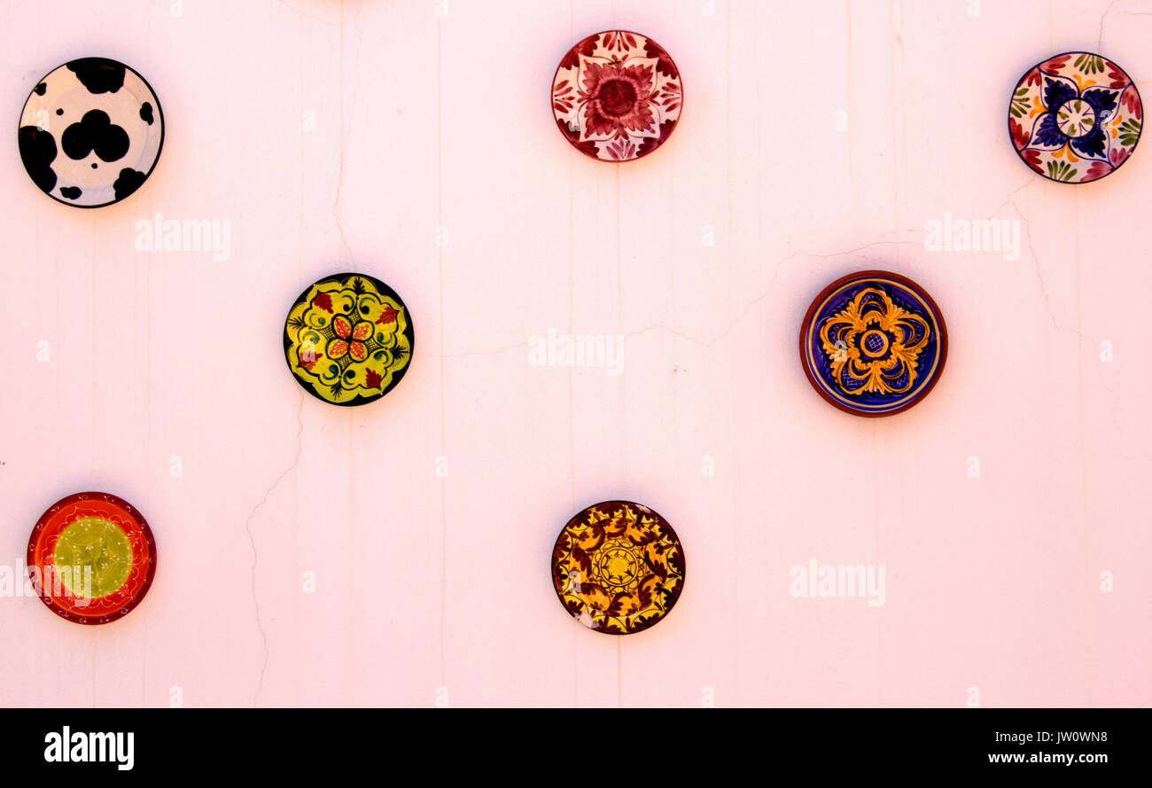 Dishes. Beautiful Spanish white wall with dishes. Traditional design ...