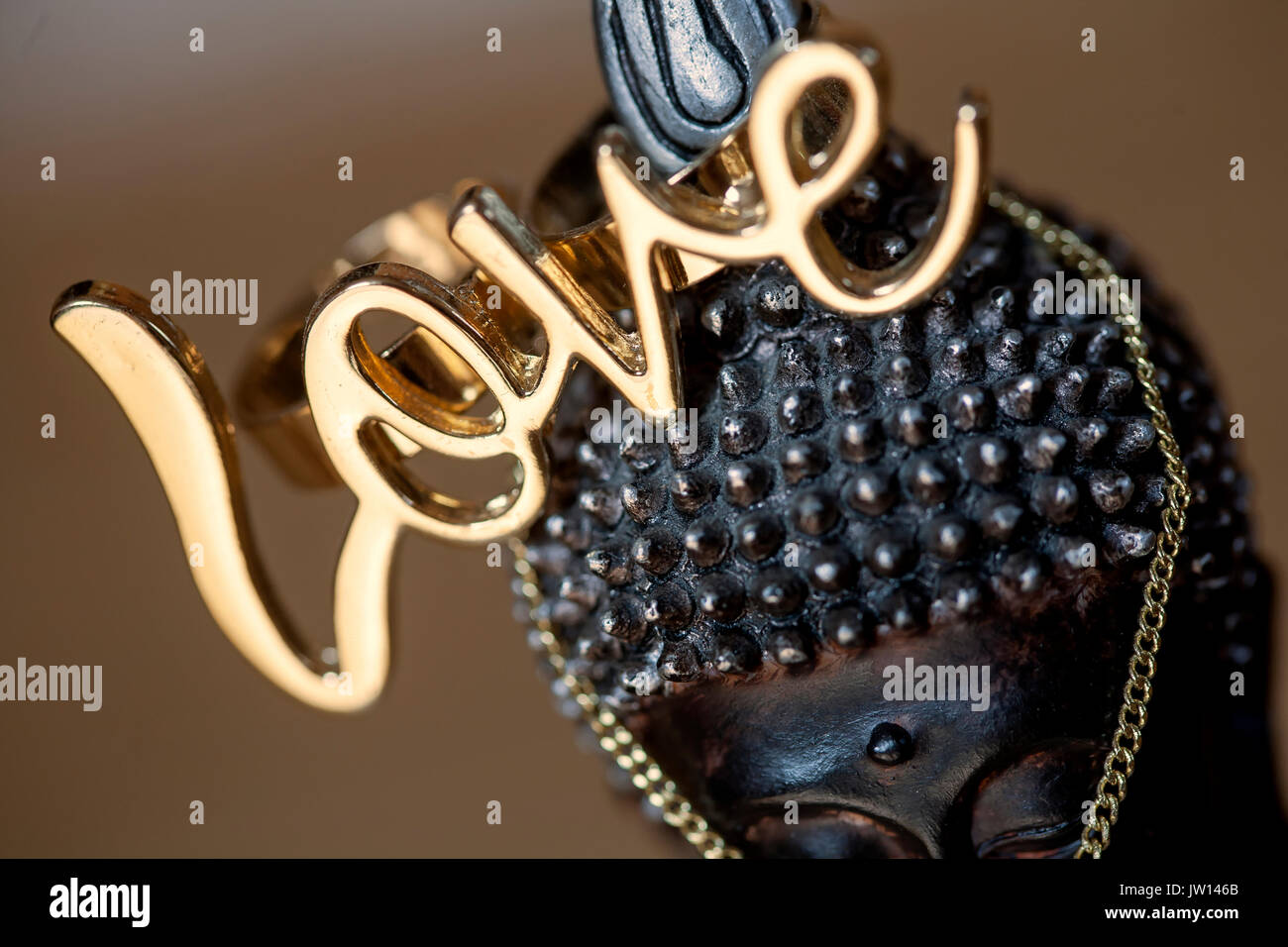 Golden love sign on Buddha's head Stock Photo - Alamy