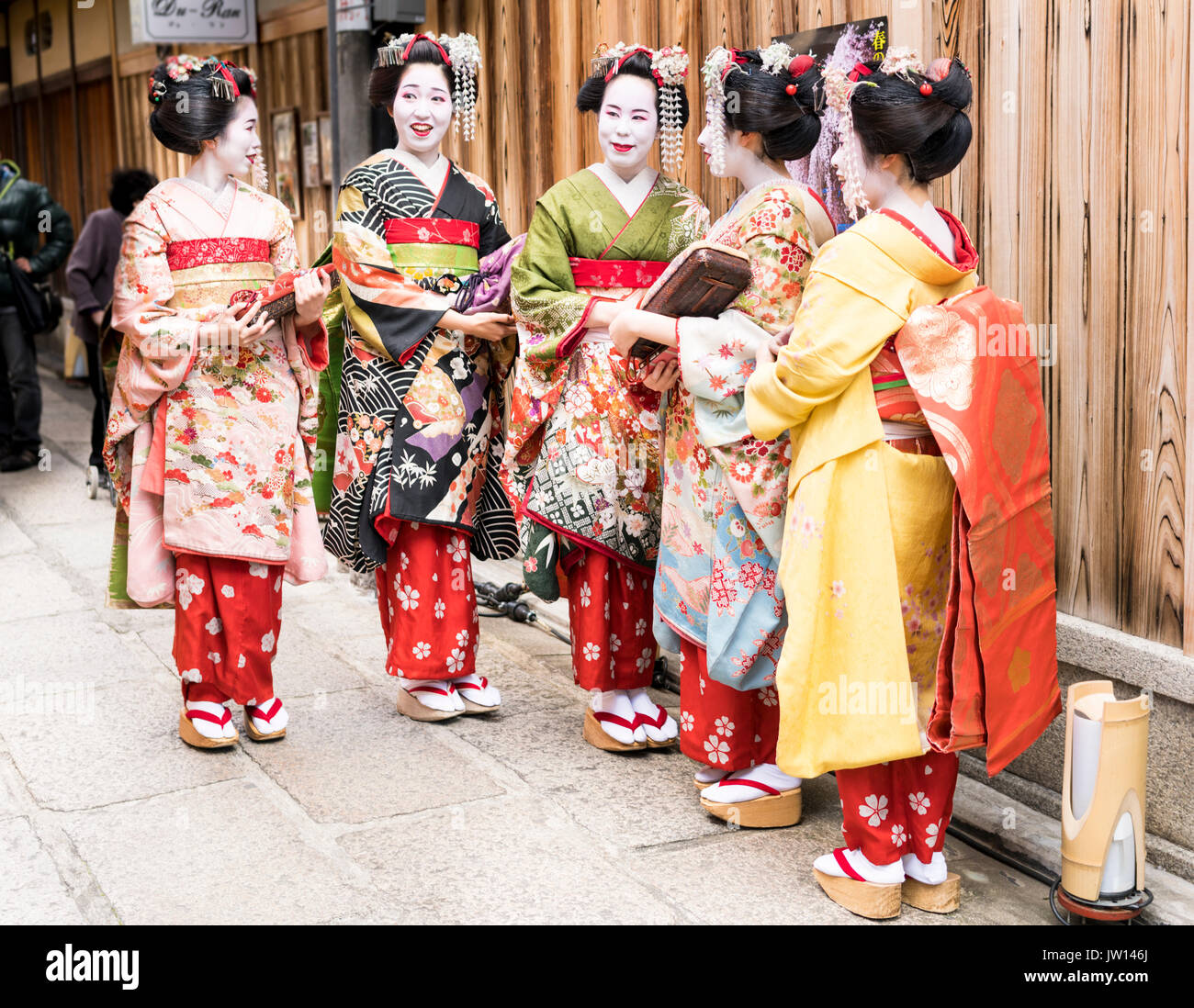 Five Geisha in stunning kimonos, posing for photos, in a traditional ...