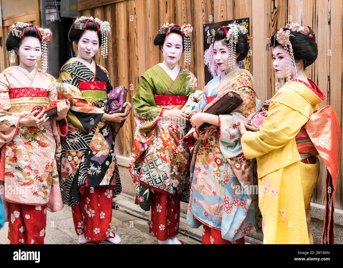 Five Geisha in stunning kimonos, posing for photos, in a traditional ...