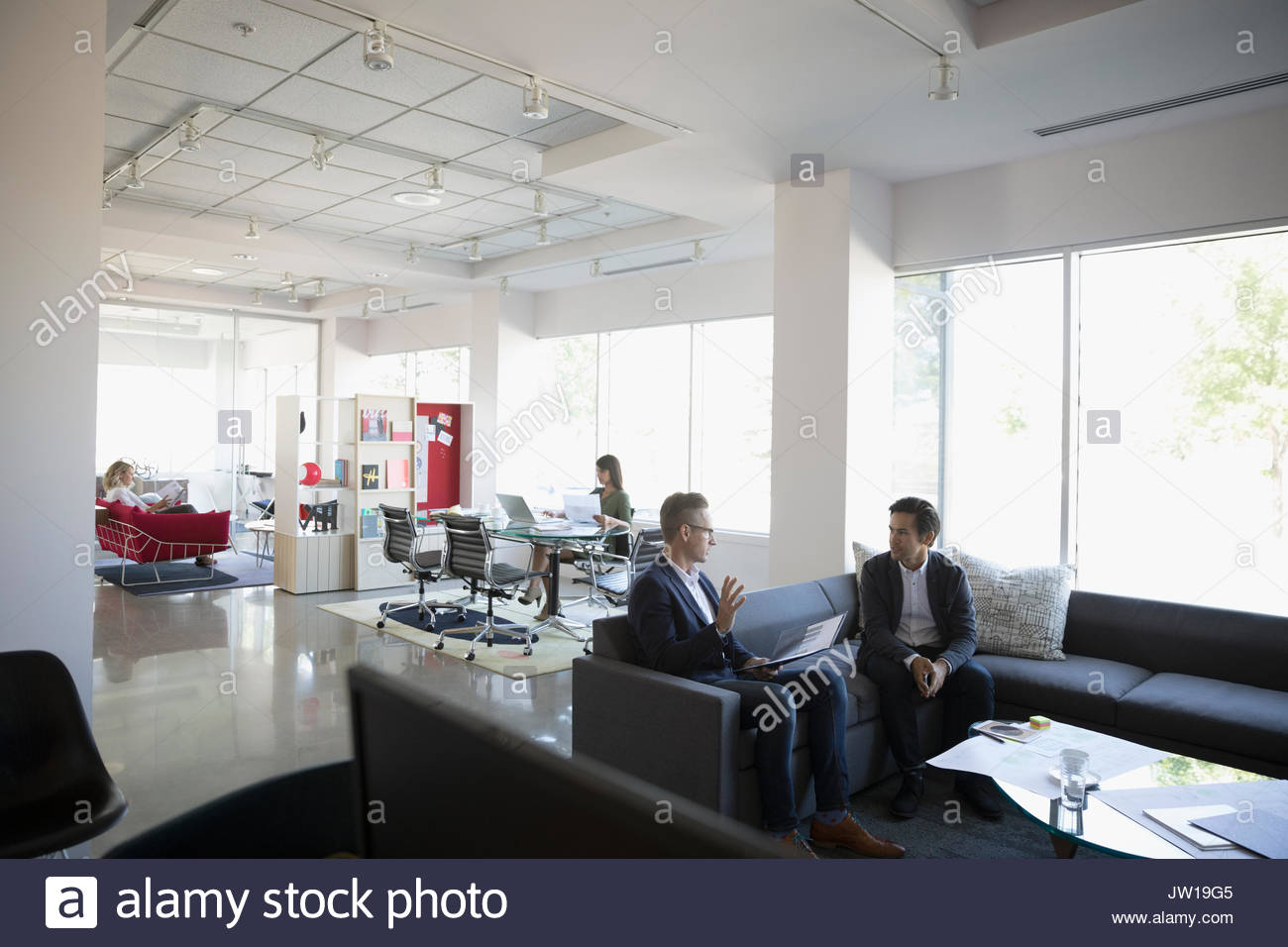 Two businessmen sitting on sofa hi-res stock photography and images - Alamy