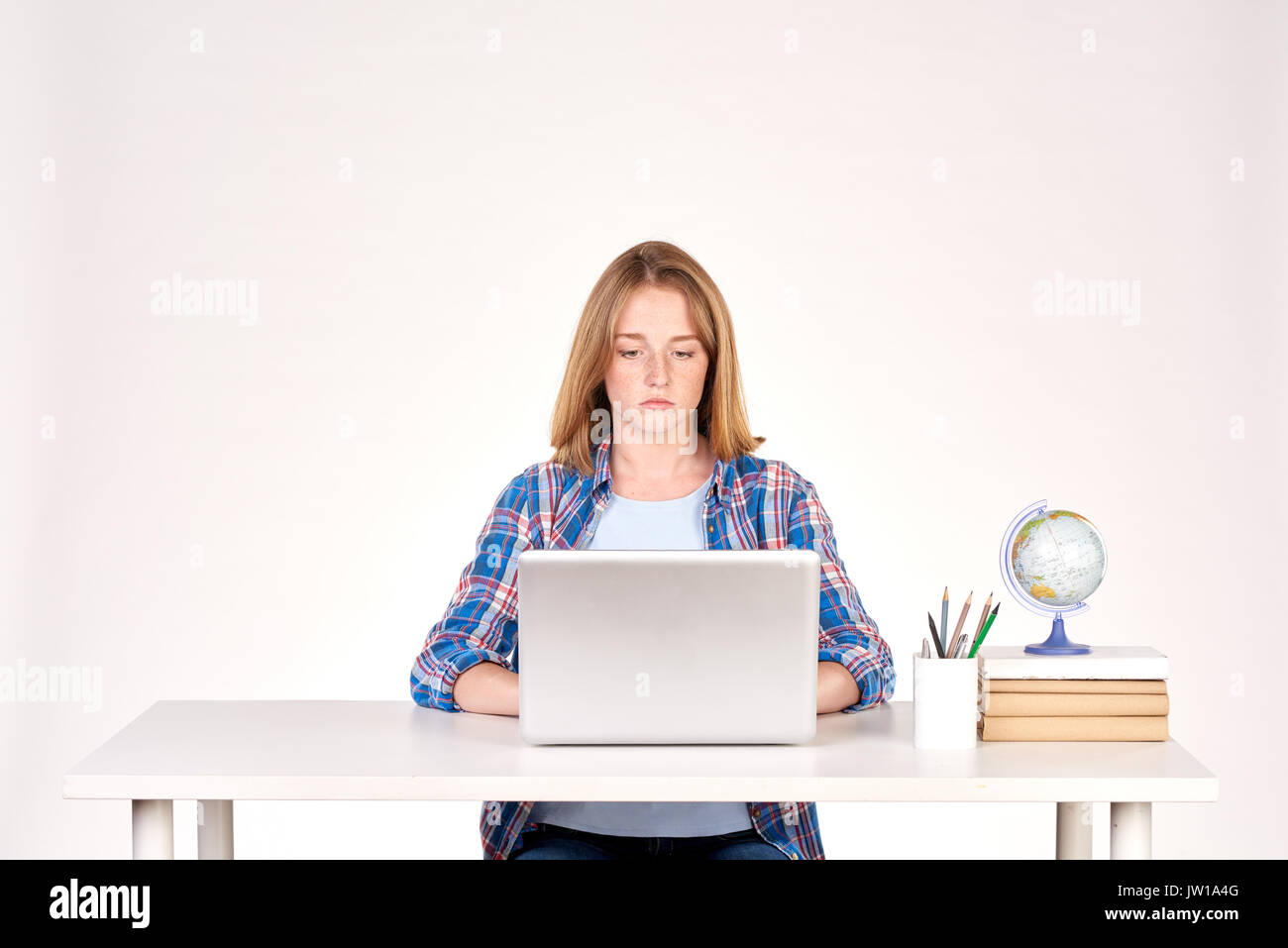 Teenage student at desk Stock Photo - Alamy