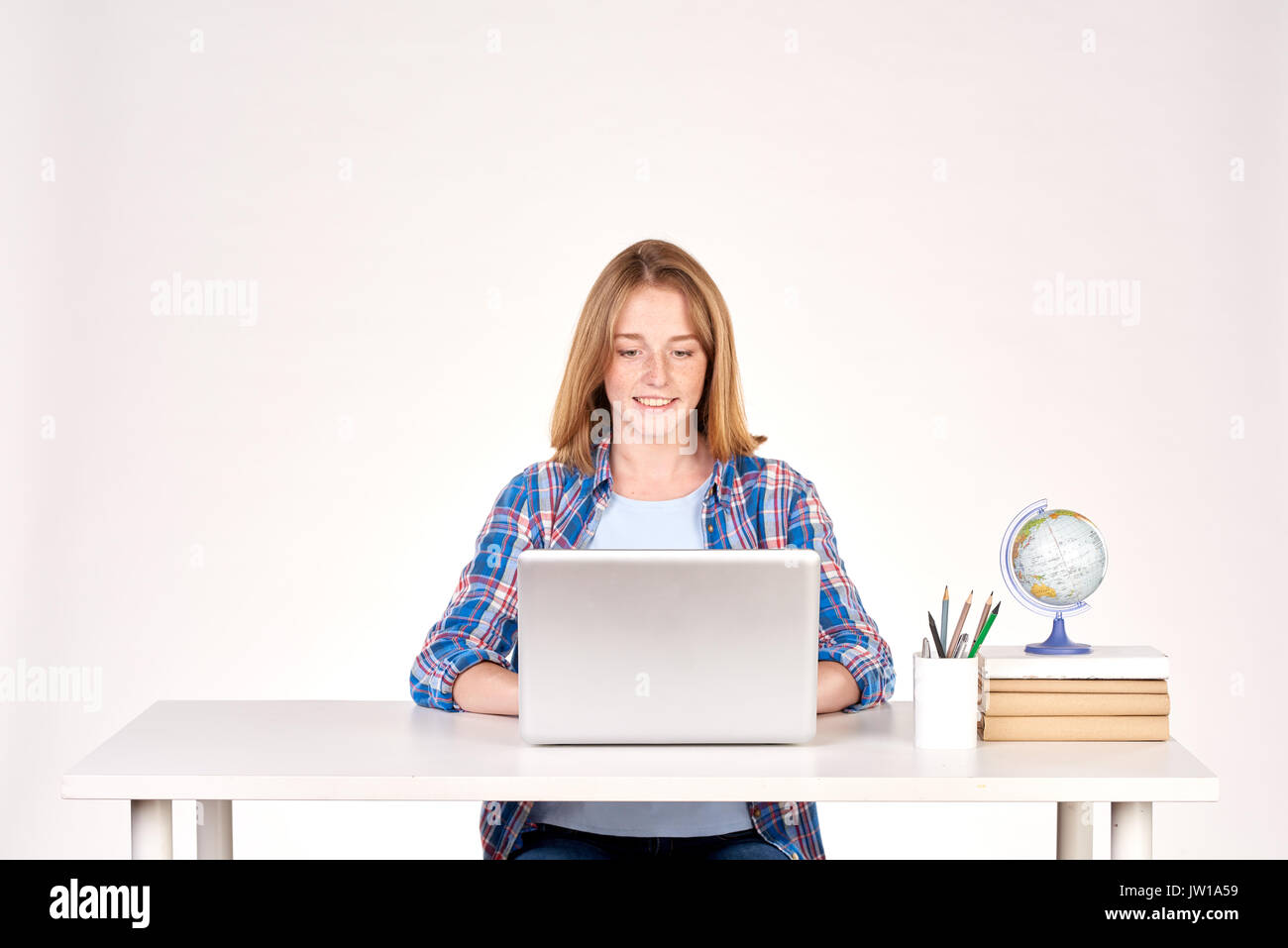 Teenage student at desk Stock Photo - Alamy