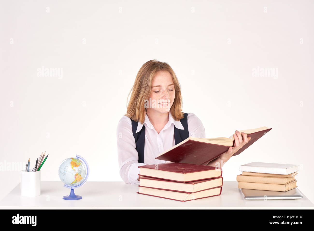 Girl studying at desk Stock Photo - Alamy