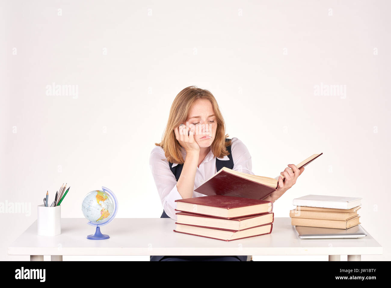 Girl studying at desk Stock Photo - Alamy