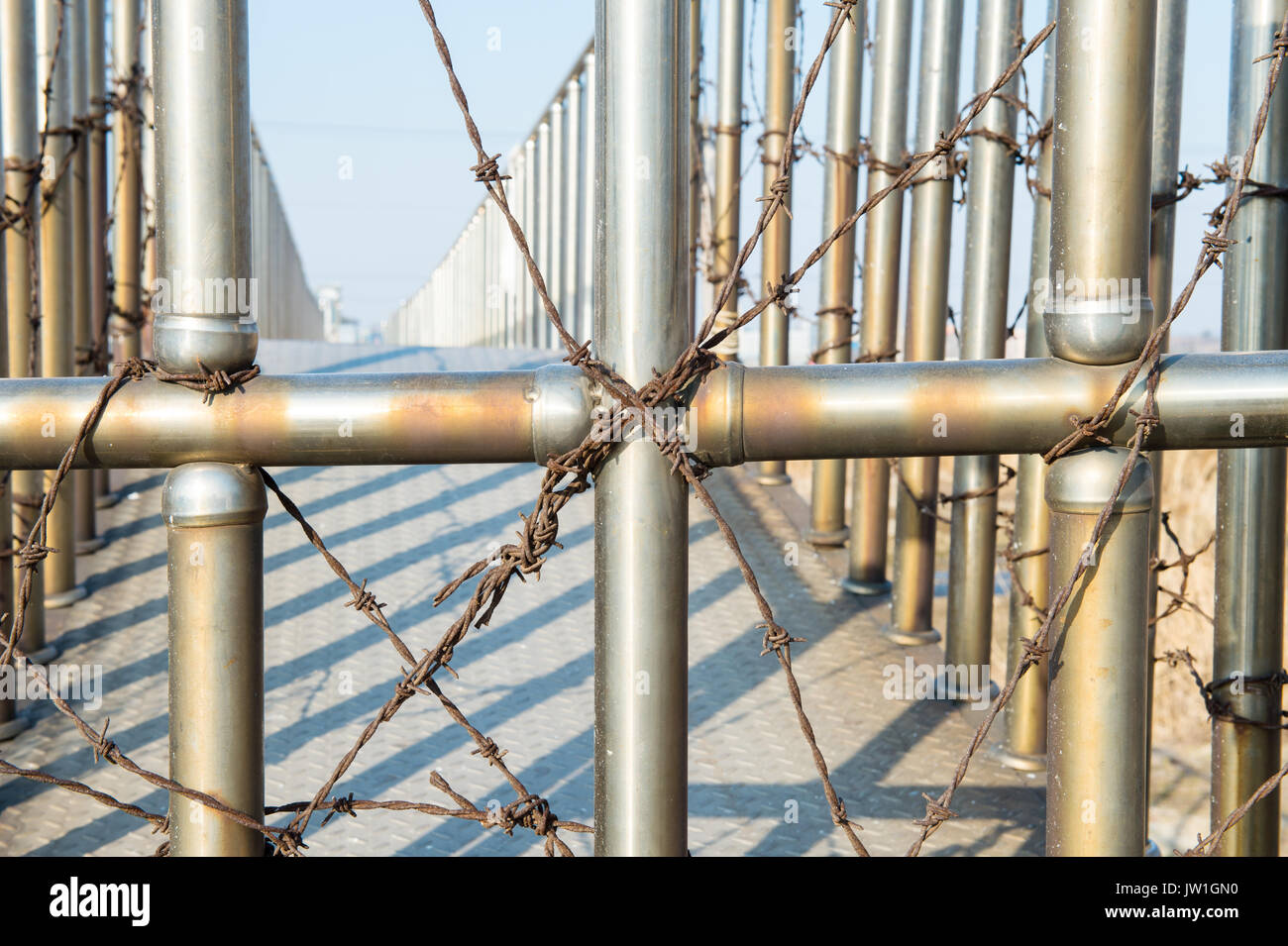 Barbed wire fence Stock Photo - Alamy