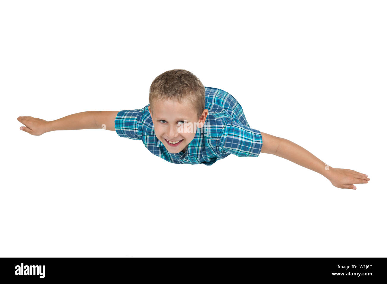 Little boy with outspread arms in front of white background in flight ...