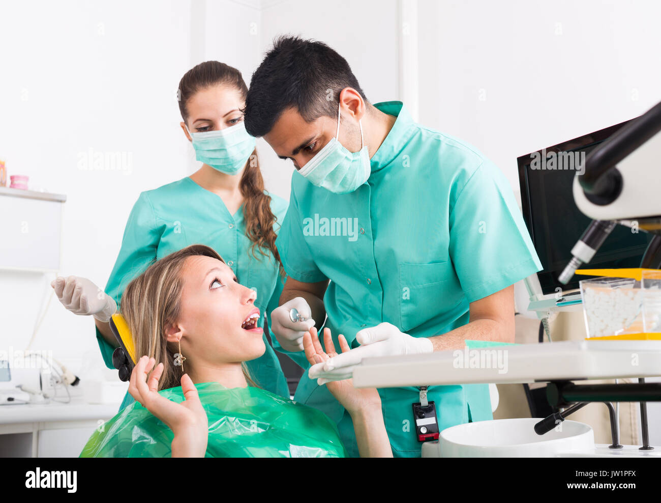 Portrait of doctor and frightened patient at dental office Stock Photo ...