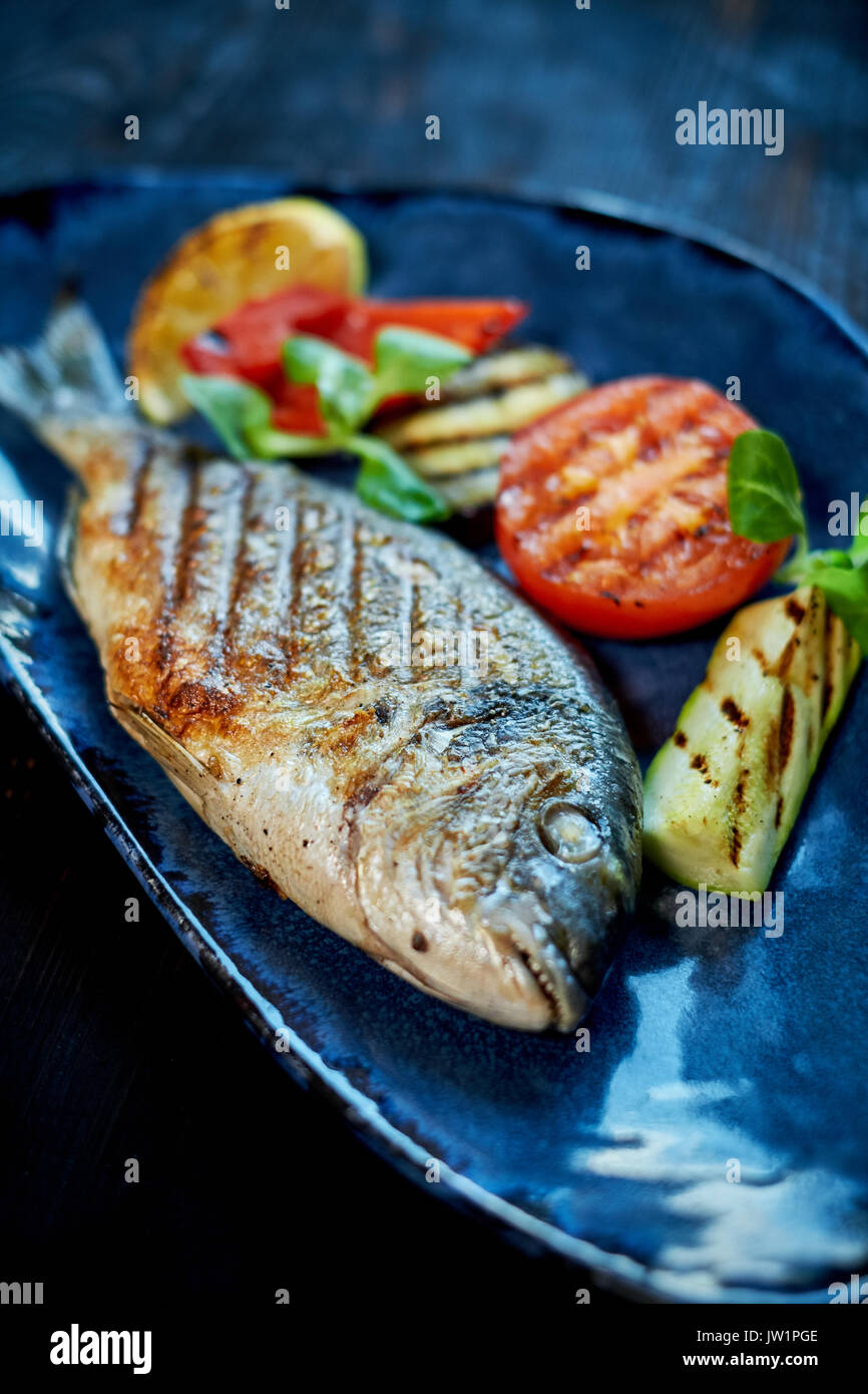 Grilled Fish dish - roasted fish and vegetables jpg Stock Photo - Alamy