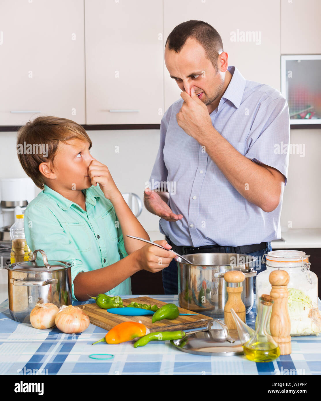 Father and teenage son cooking the dinner and smiling Stock Photo - Alamy