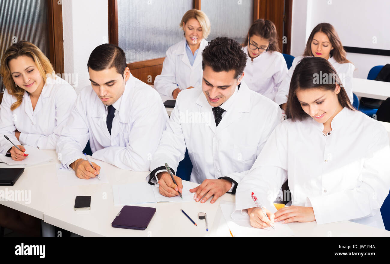 Group of positive scientists in white uniform at advanced training ...