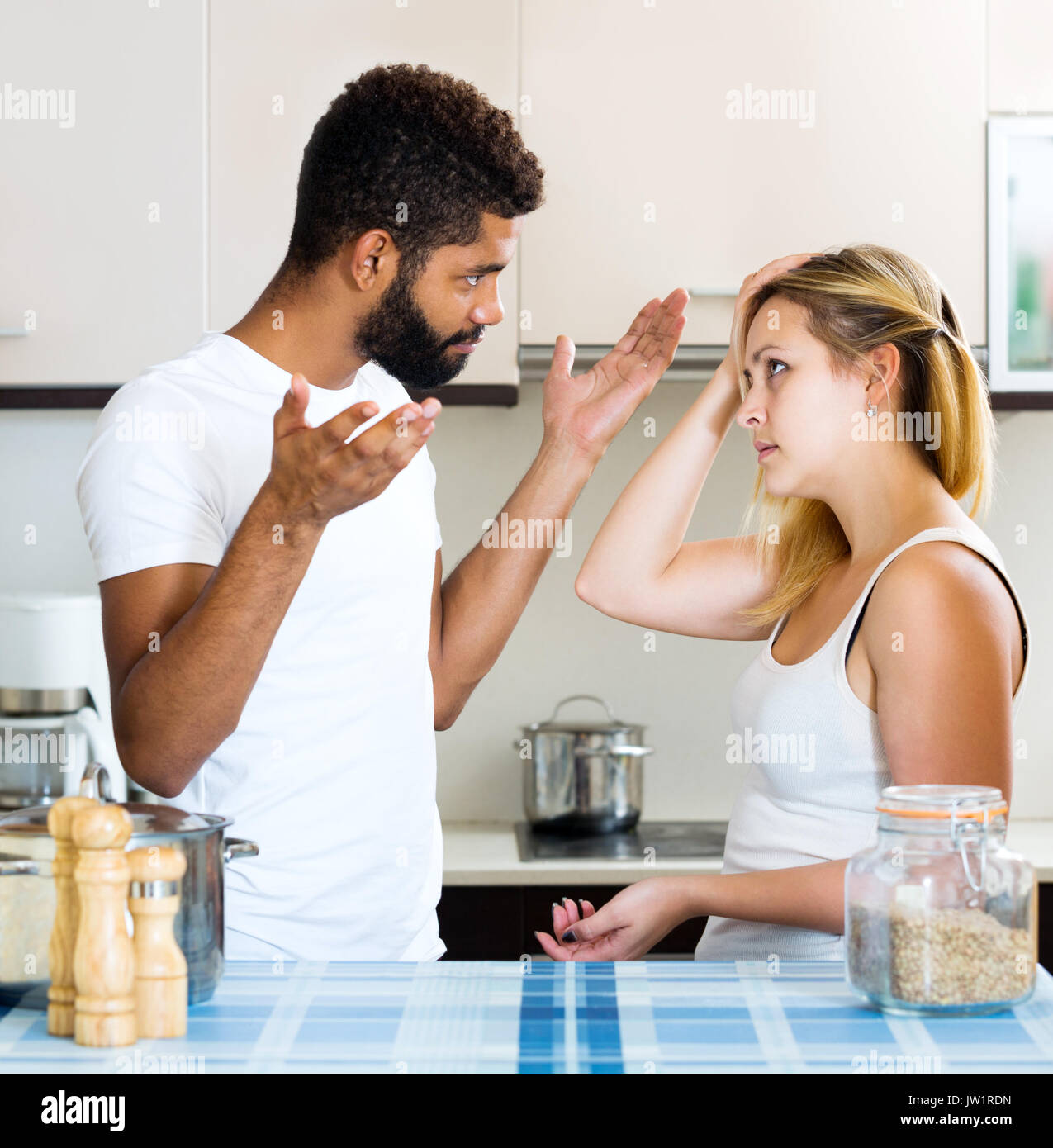 Sad young guy and white crying woman fighting in domestic kitchen Stock ...