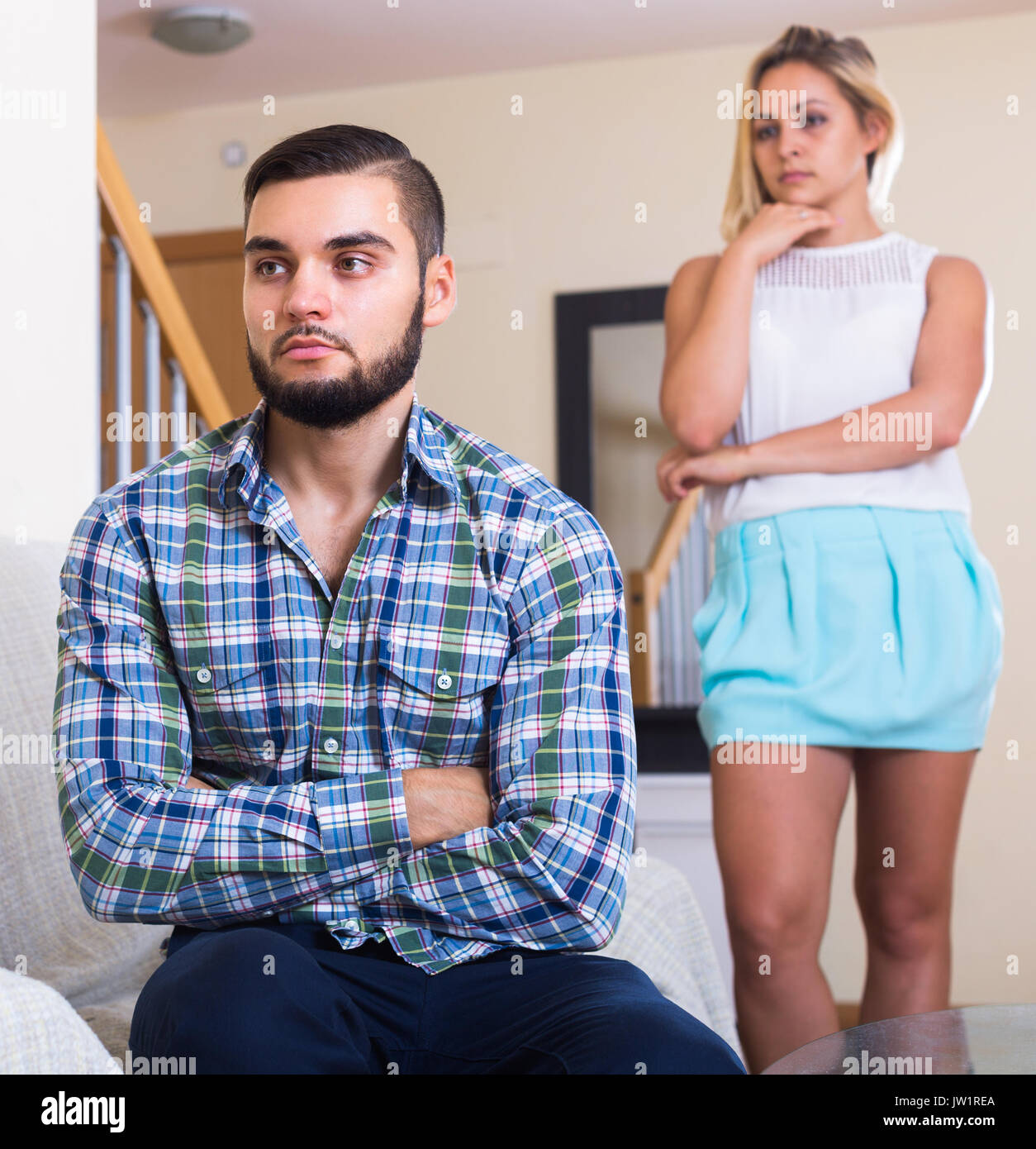 Frustrated young guy and his displeased girlfriend having conflict ...