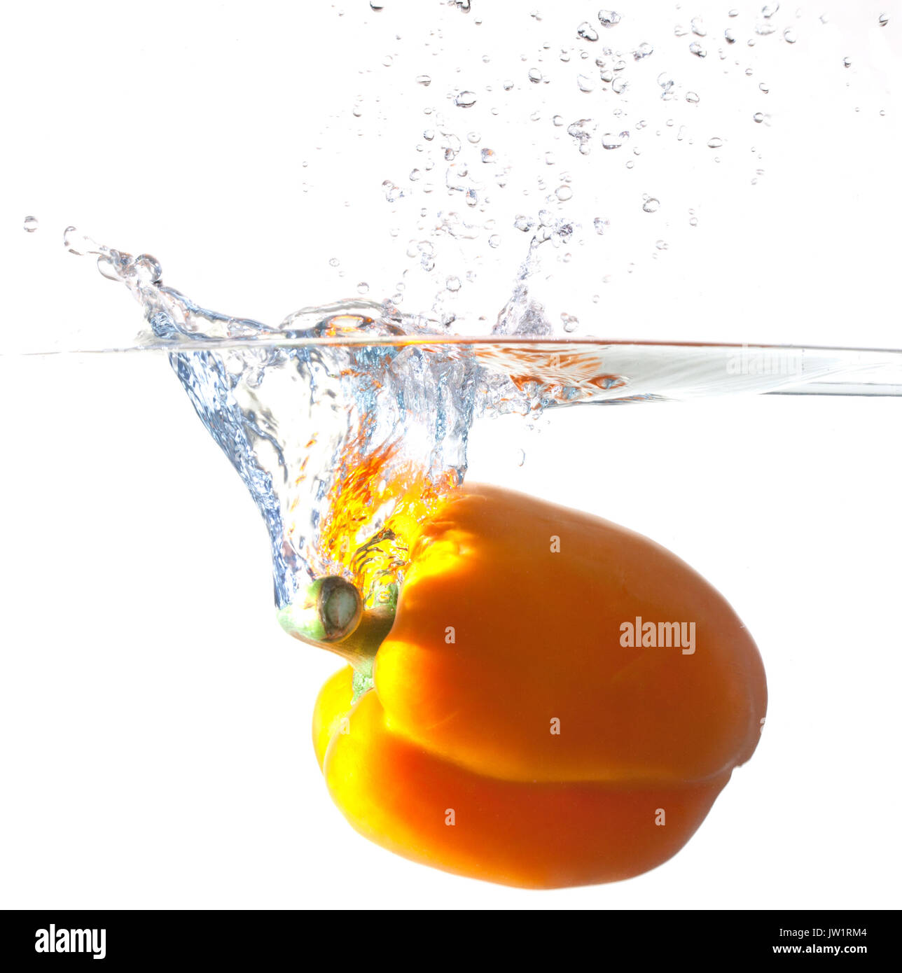 Orange Bell Pepper Dropping Into Water Stock Photo - Alamy