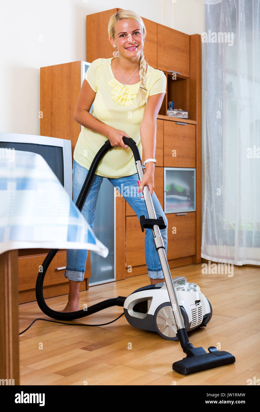 Hoovering woman smile hi-res stock photography and images - Alamy