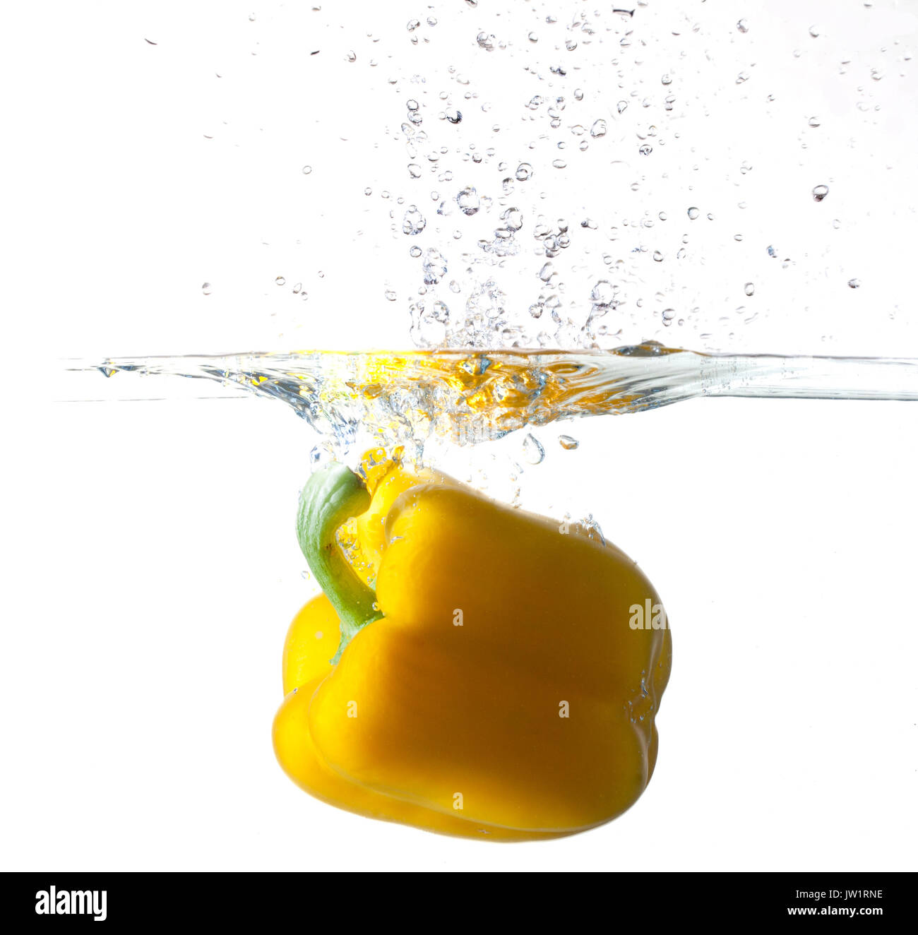Yellow Bell Pepper Dropping Into Water Stock Photo - Alamy