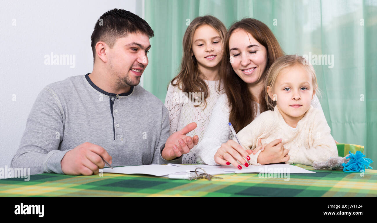 Young russian parents with little children buying insurance and smiling ...