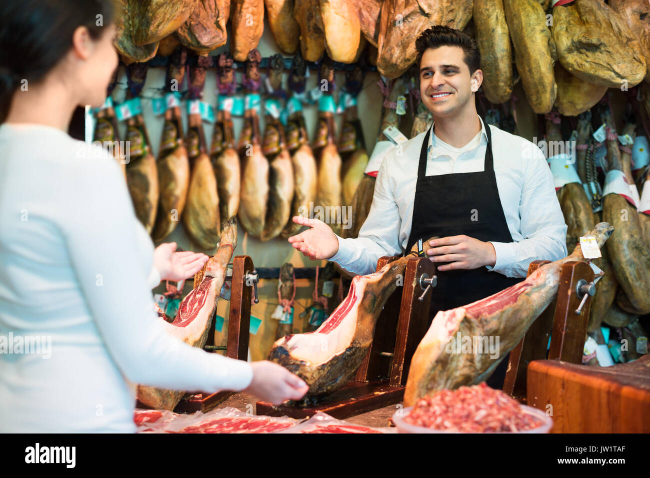 Female customer buying a Spanish jamon at delicatessen store Stock ...