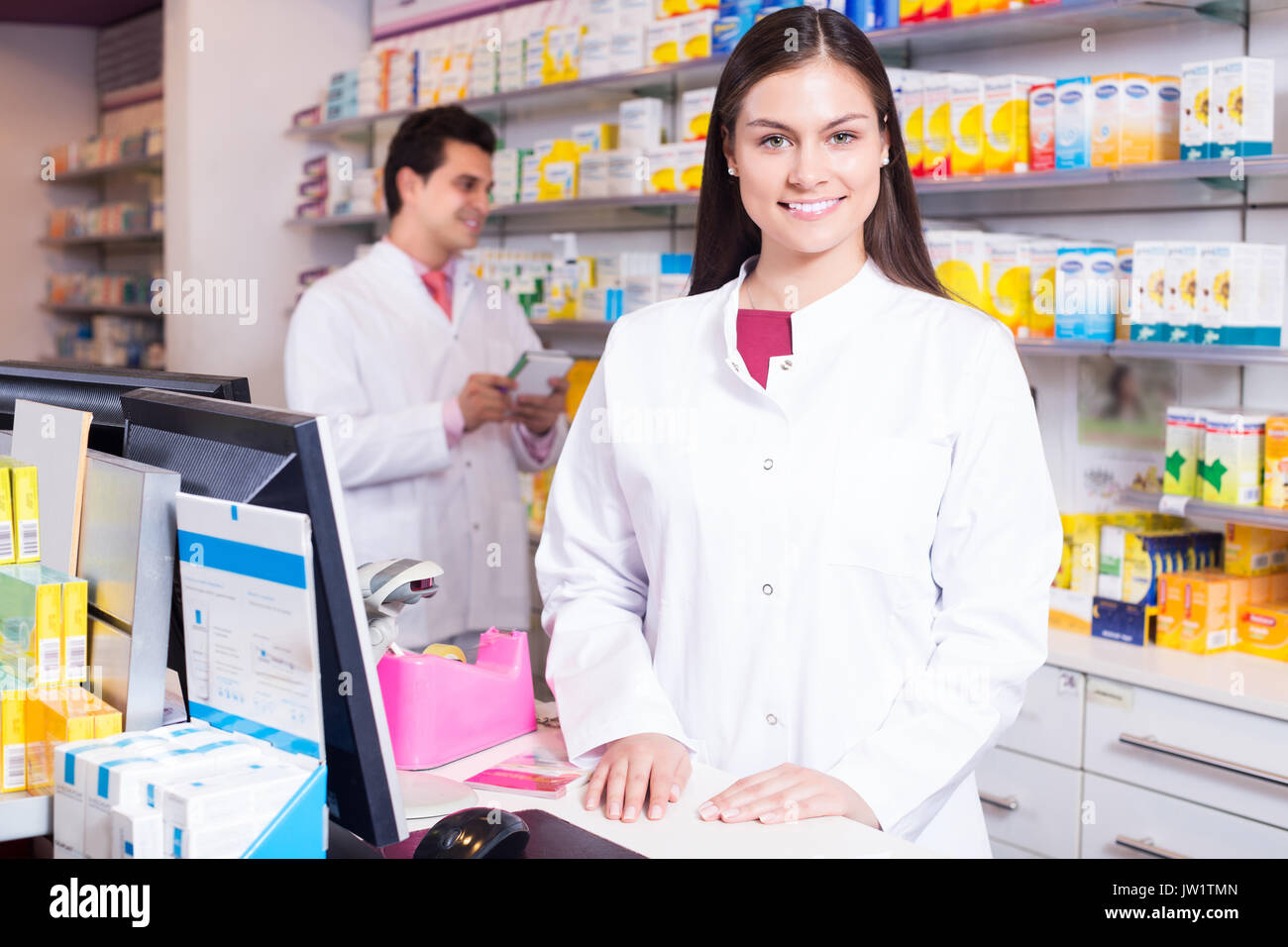 Portrait of pharmacist and assistant working at farmacy reception Stock ...