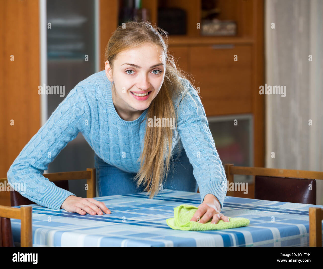 Young housewife dusting table as doing clean-up indoors Stock Photo - Alamy