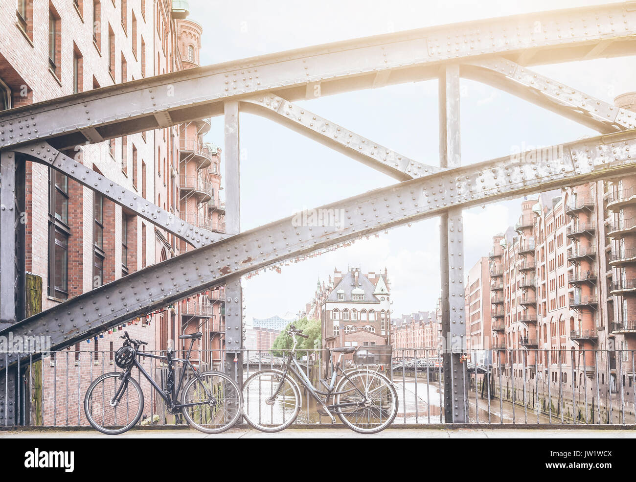 bicycles parked against iron handrail on a bridge in the old warehouse ...