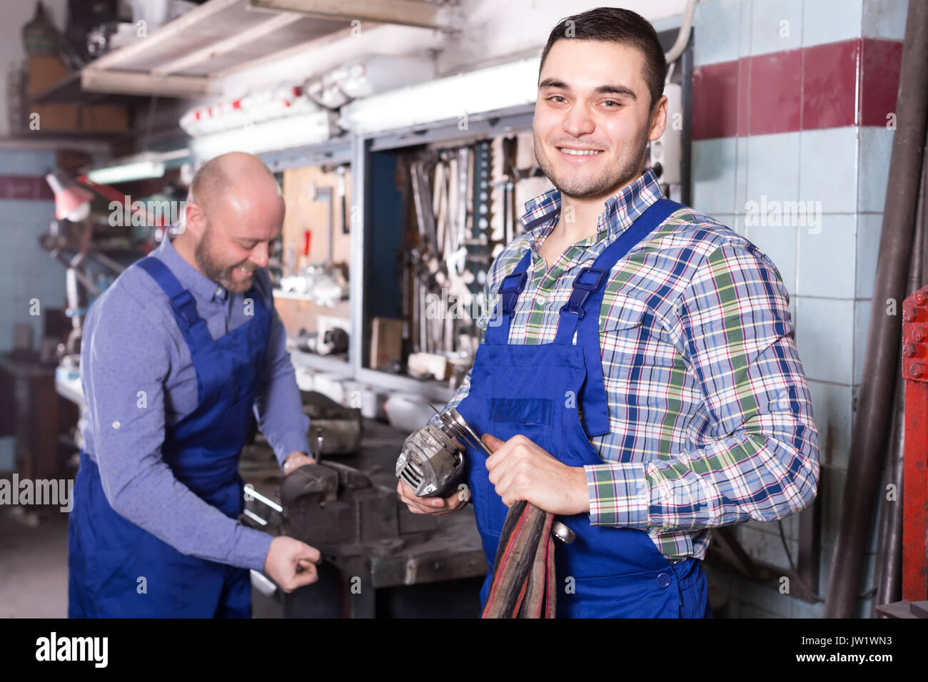 Portrait two men fixing hi-res stock photography and images - Alamy