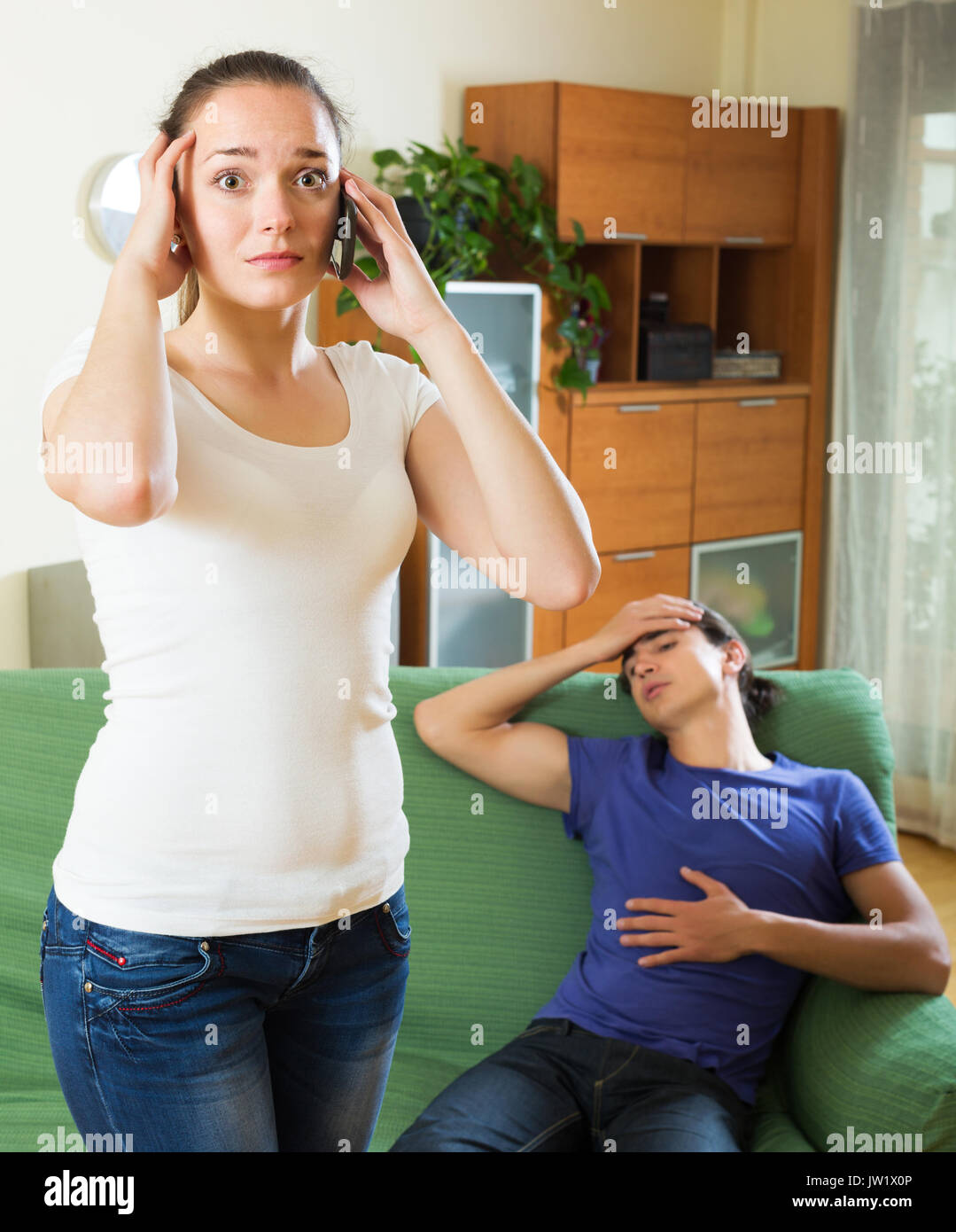 Scared woman calling to emergency for man Stock Photo - Alamy