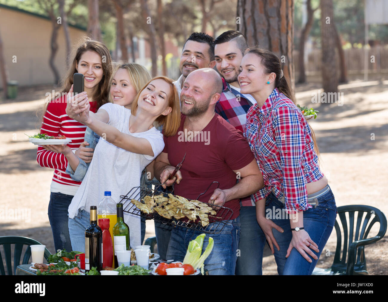 Happy adults relaxing at picnic and doing a selfie Stock Photo - Alamy