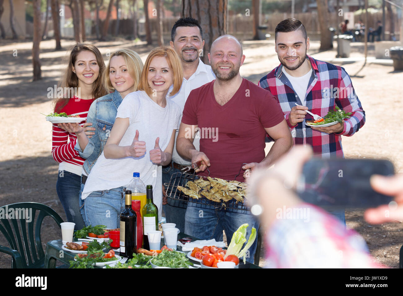Happy cheerful adults relaxing at picnic and doing the selfie Stock ...