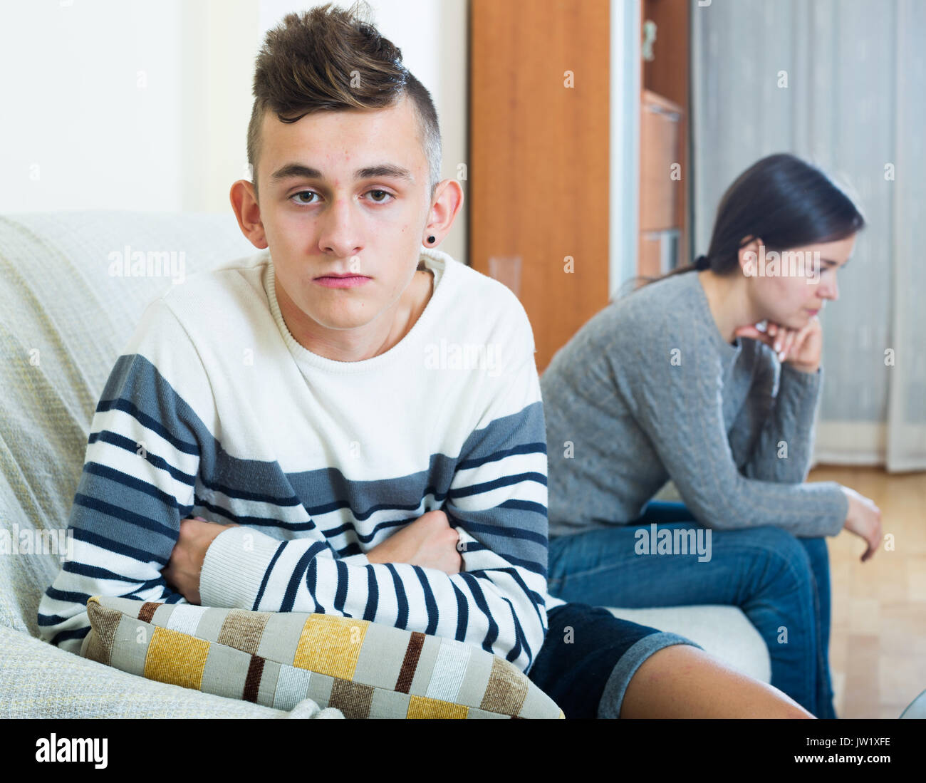 Upset mother and angry son arguing in domestic interior Stock Photo - Alamy