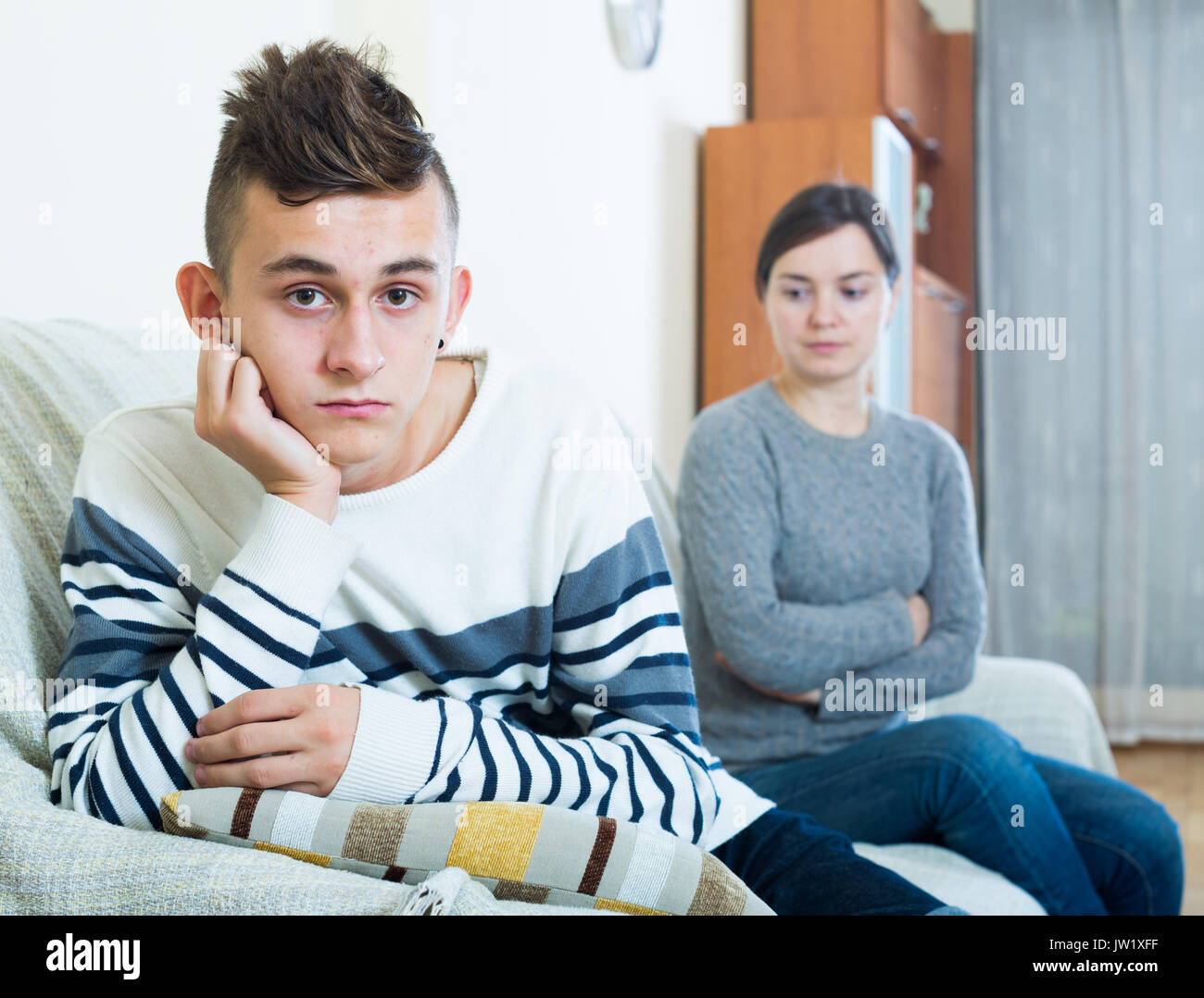 Upset mother and angry son arguing in domestic interior Stock Photo - Alamy
