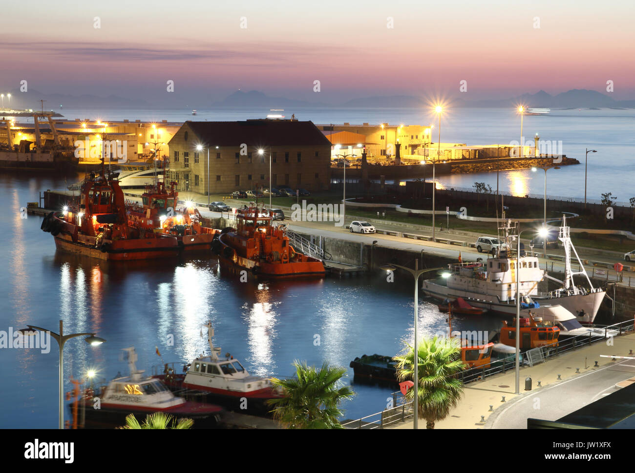 harbor of Vigo at sunset with the illumination and reflections and ...