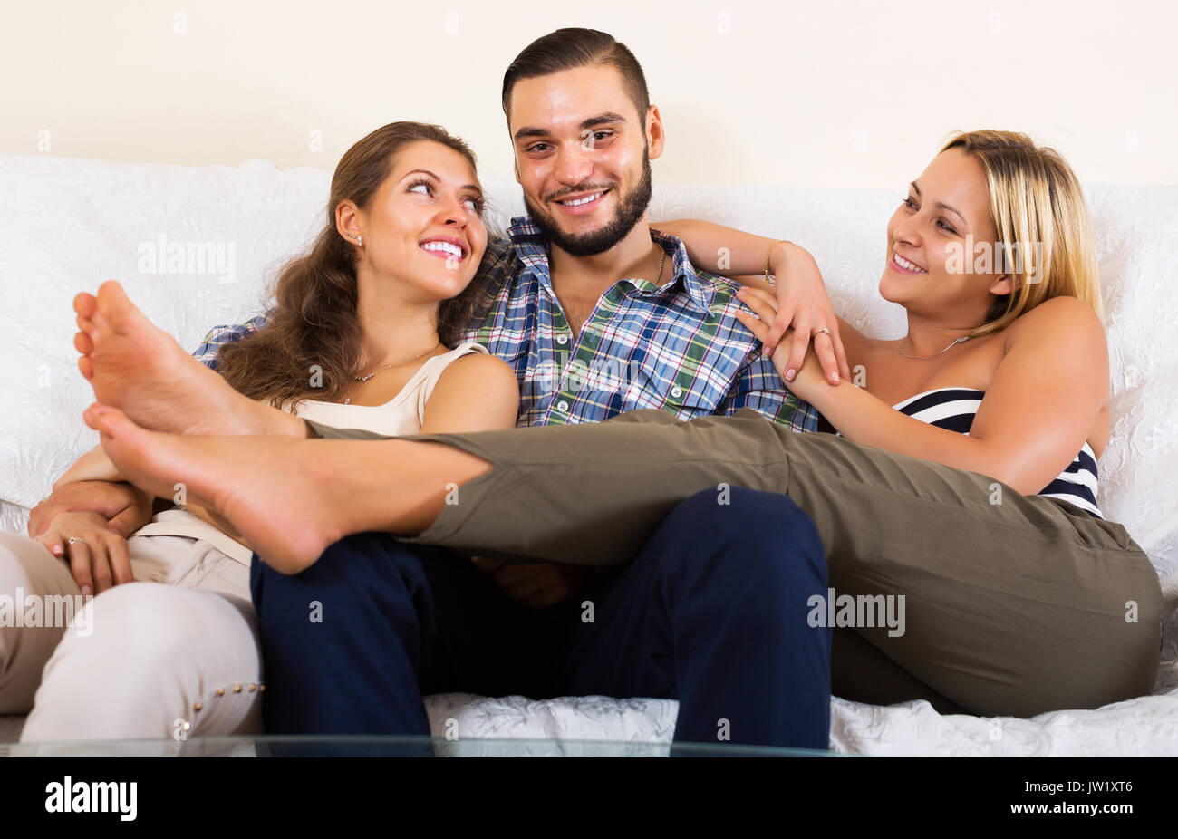 Portrait of two smiling charming girls with young boyfriend Stock Photo ...